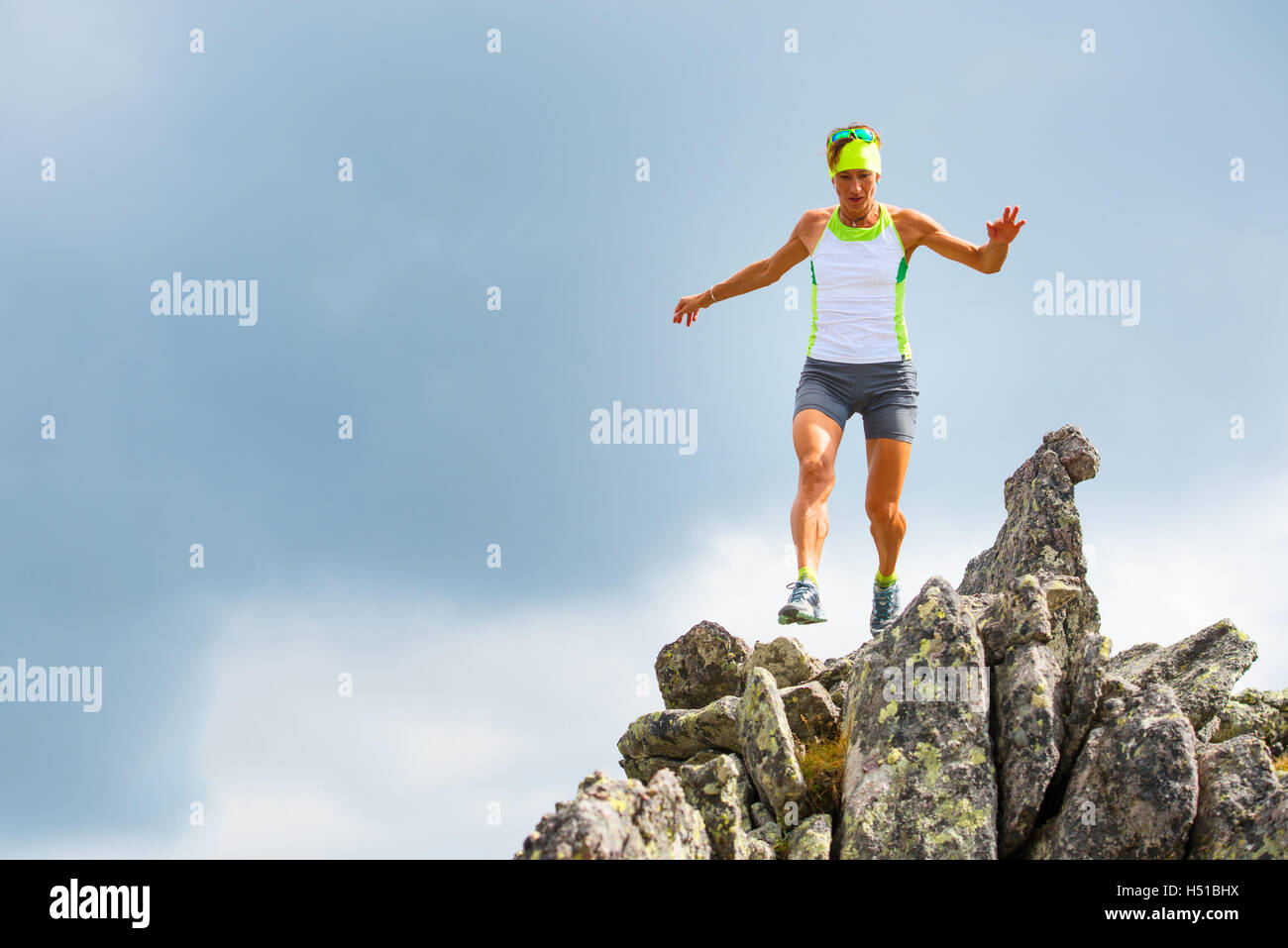 Female athlete of mountain running trains on the stones Stock Photo - Alamy