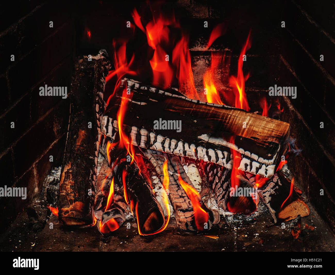 Fireplace with burning wood and fire. Closeup Stock Photo - Alamy
