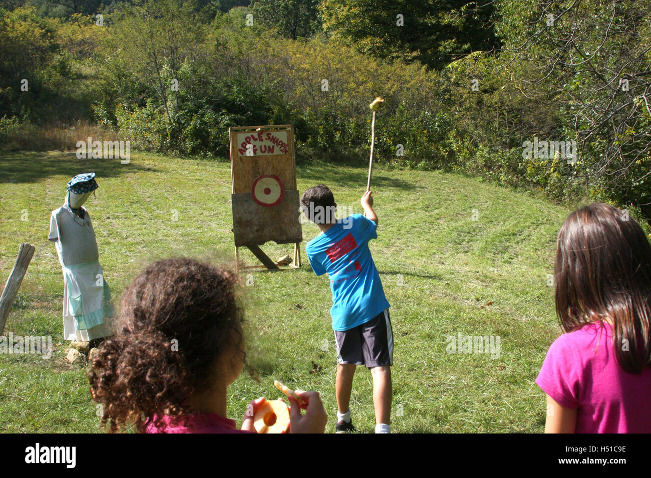 Young boy playing a target game on a farm Stock Photo - Alamy