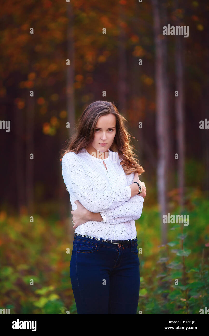 Beautiful woman in the autumn forest. Young brunette girl Stock Photo ...