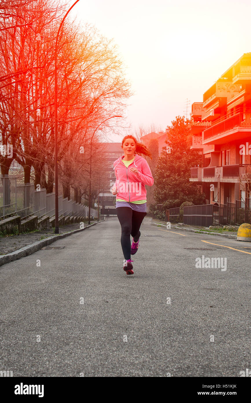 Girl gets jogging in the street in the city at dawn Stock Photo - Alamy