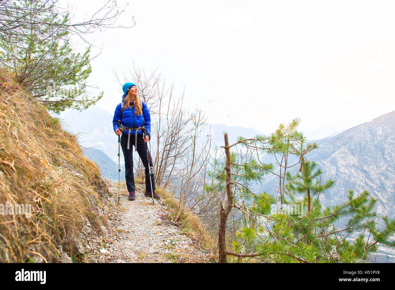 Girl looks the view during a trek in a mountain trail Stock Photo - Alamy