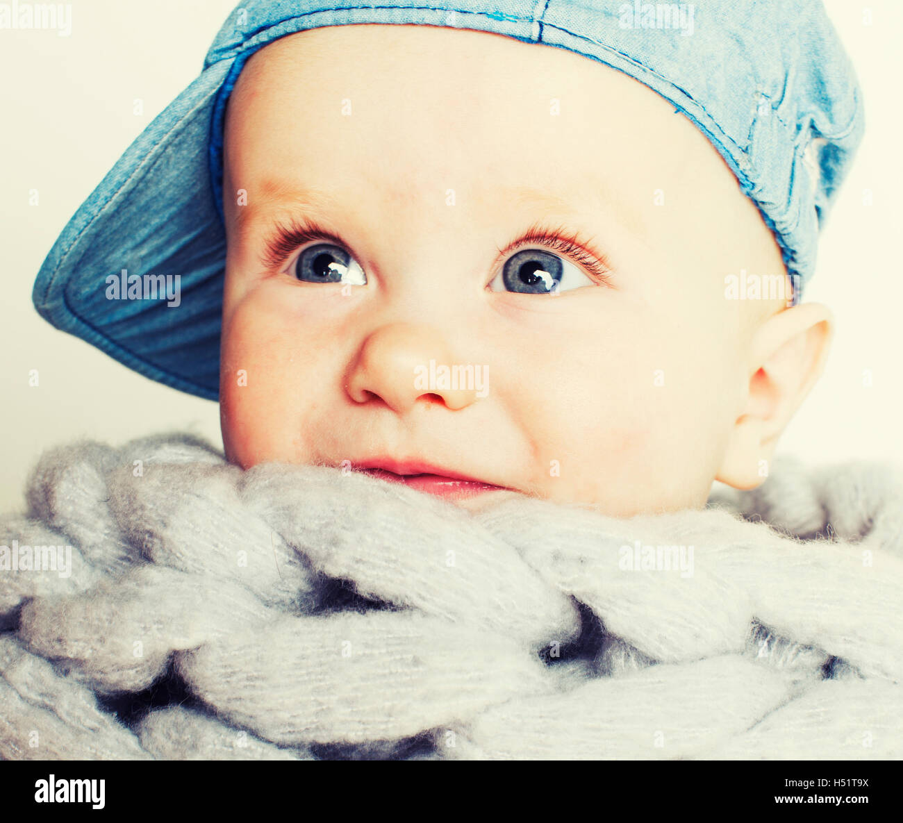 little cute red head baby in scarf all over him close up isolate Stock ...