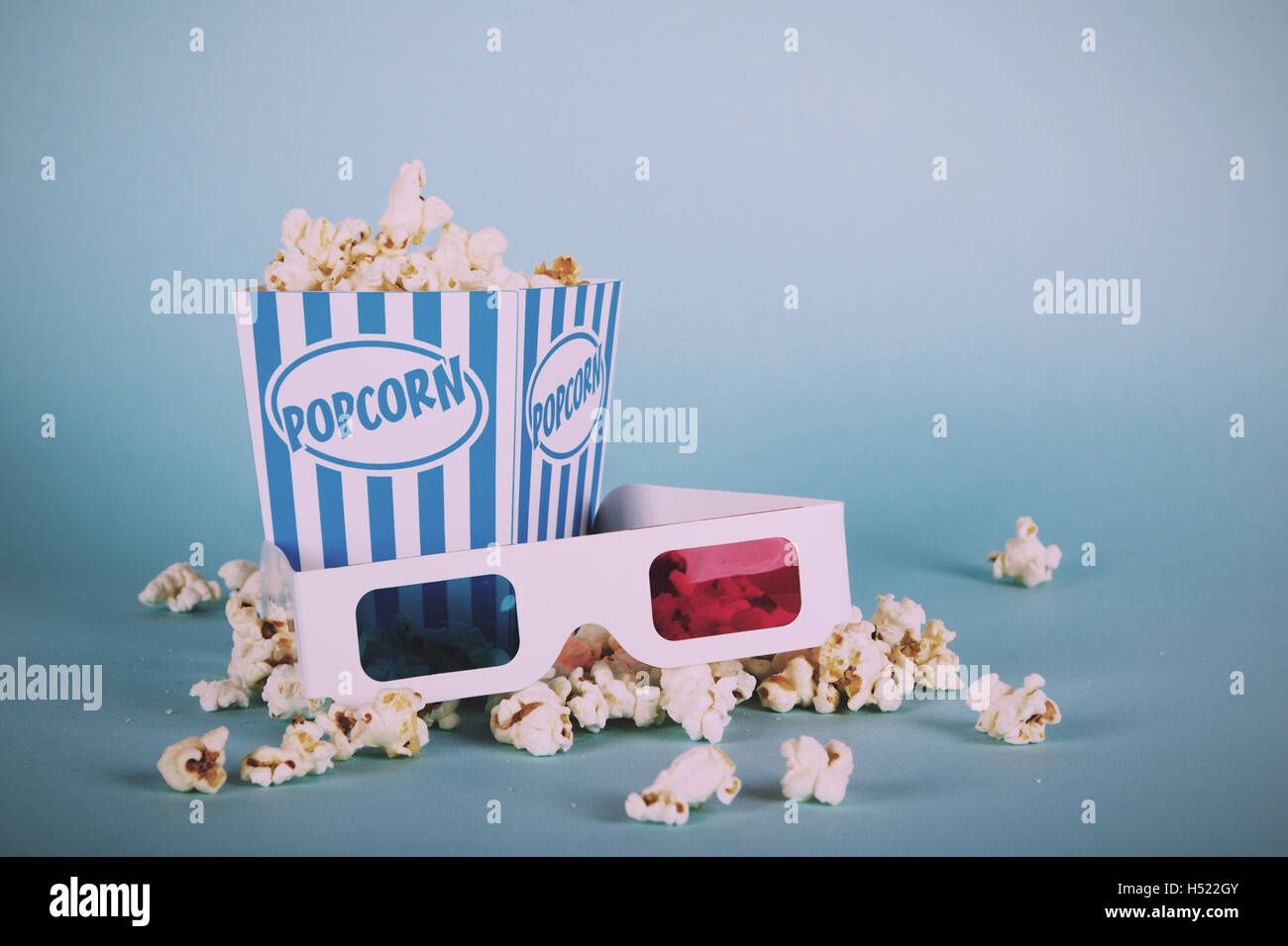Bucket of popcorn against a blue background Vintage Retro Filter Stock ...