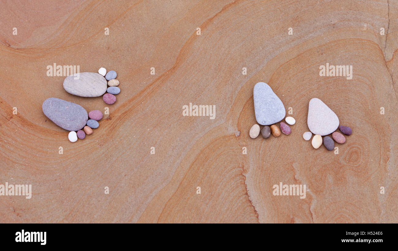 Fun rock art making feet with pebbles at the beach. Pebble feet Stock ...