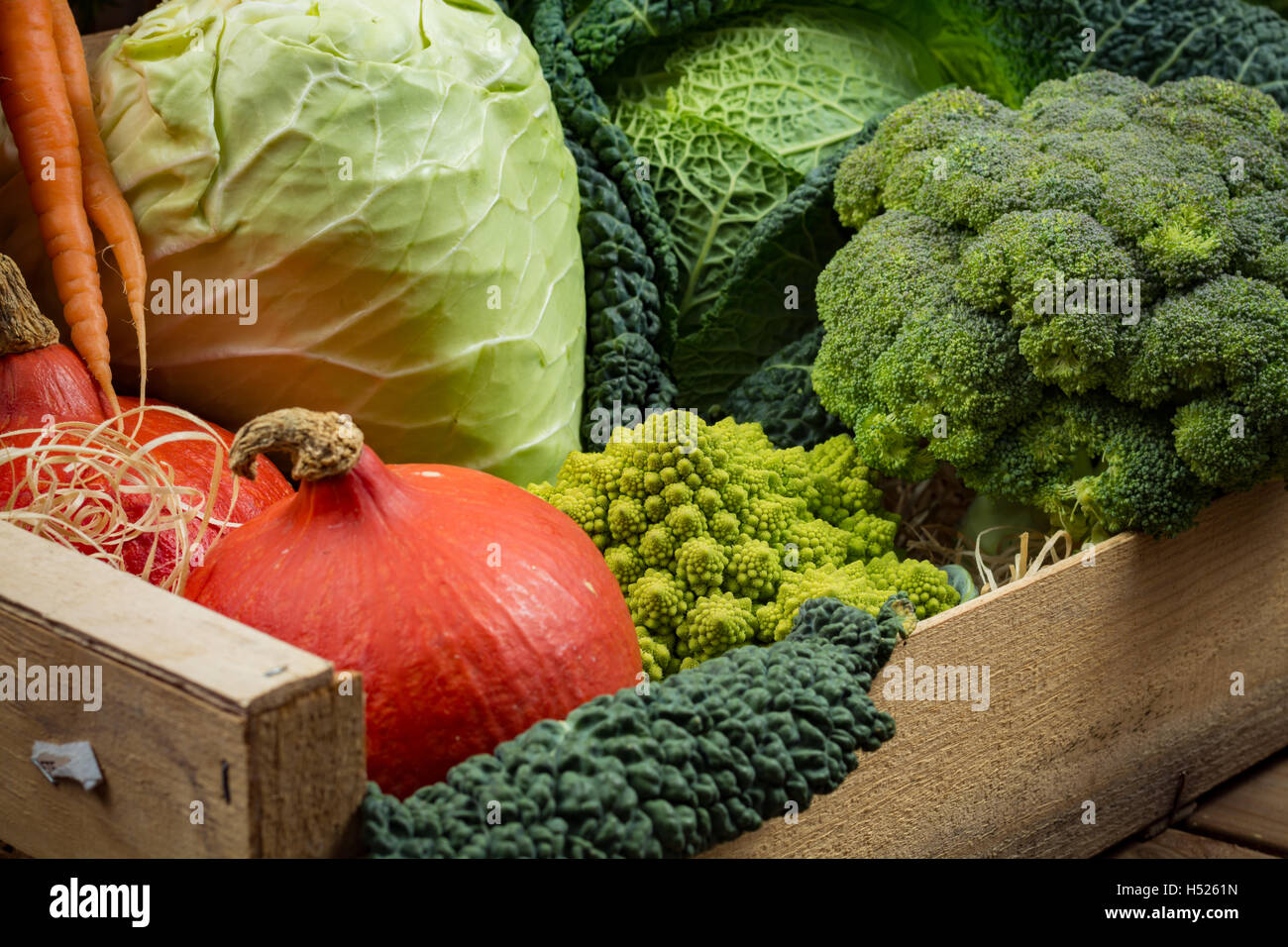 Green and orange fresh vegetables in wooden box, harvest - broccoli ...