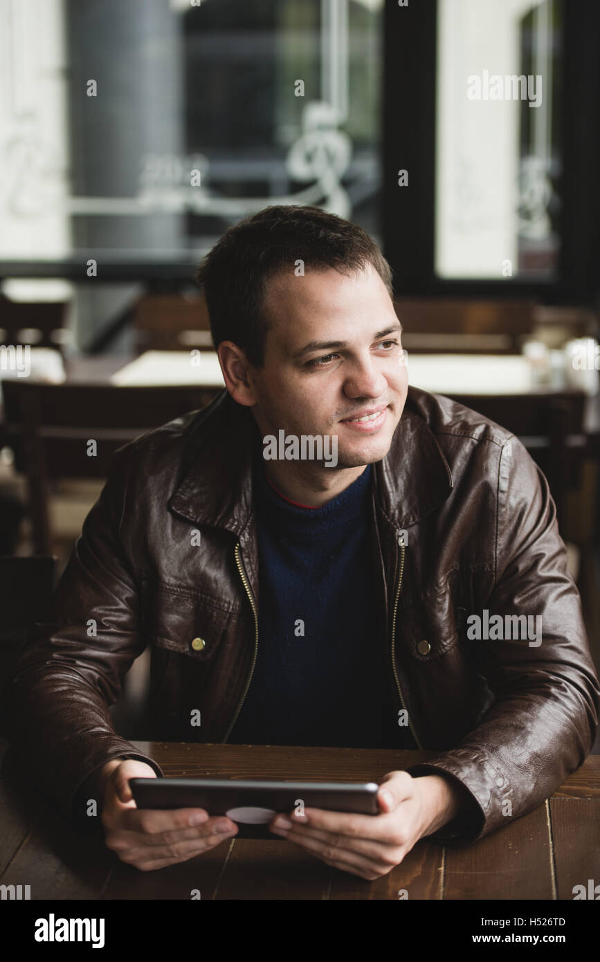 Young man or student using tablet computer in cafe Stock Photo - Alamy