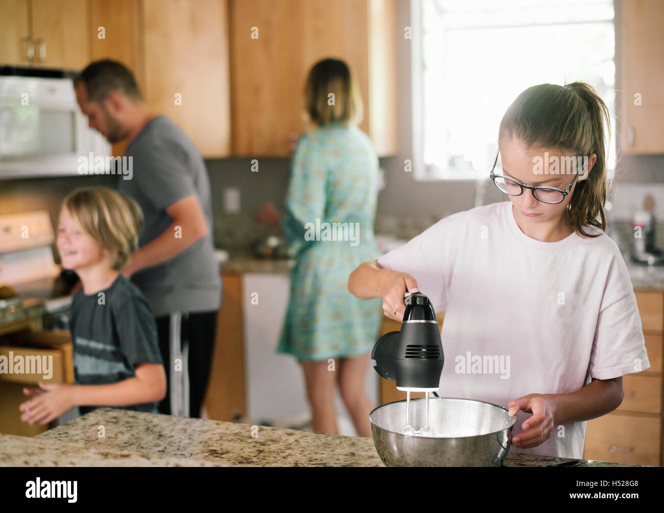 Family preparing breakfast in a kitchen Stock Photo - Alamy