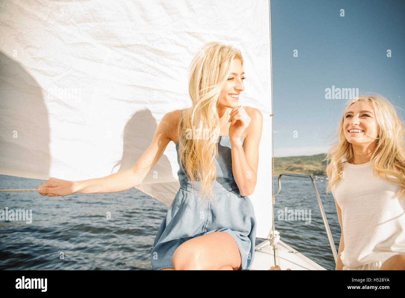 Portrait of two blond sisters on a sail boat Stock Photo - Alamy