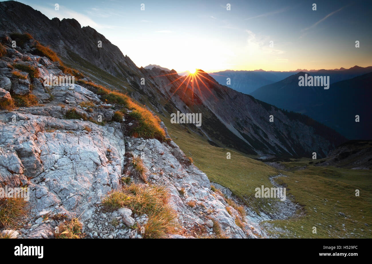 sunrise over rock in Alps, Austria Stock Photo - Alamy