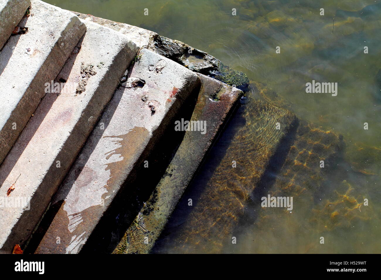Old concrete stairway steps going in to the water Stock Photo - Alamy