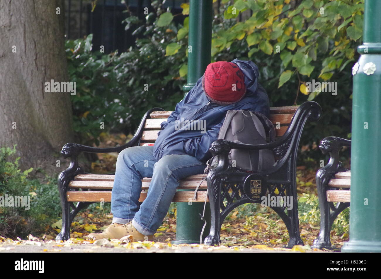 Homeless person on bench Stock Photo - Alamy