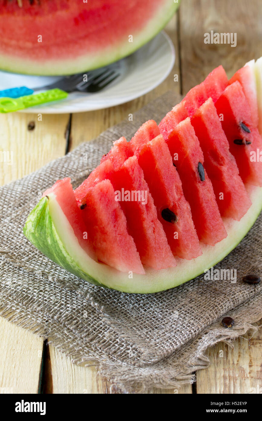 Fresh sliced watermelon, a popular summer fruit on a rustic wooden ...