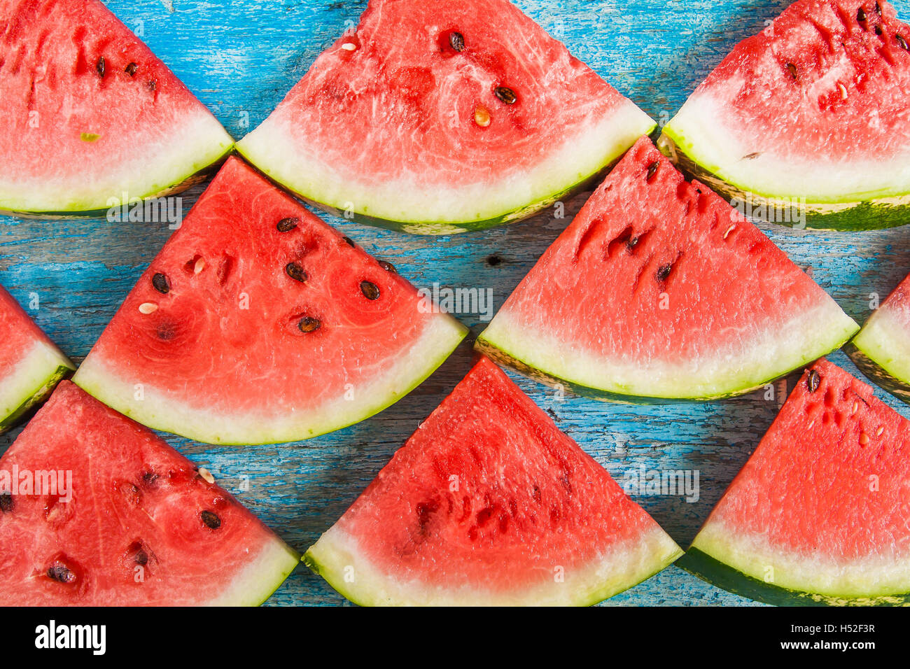 on a blue background flat triangles of watermelon Stock Photo - Alamy
