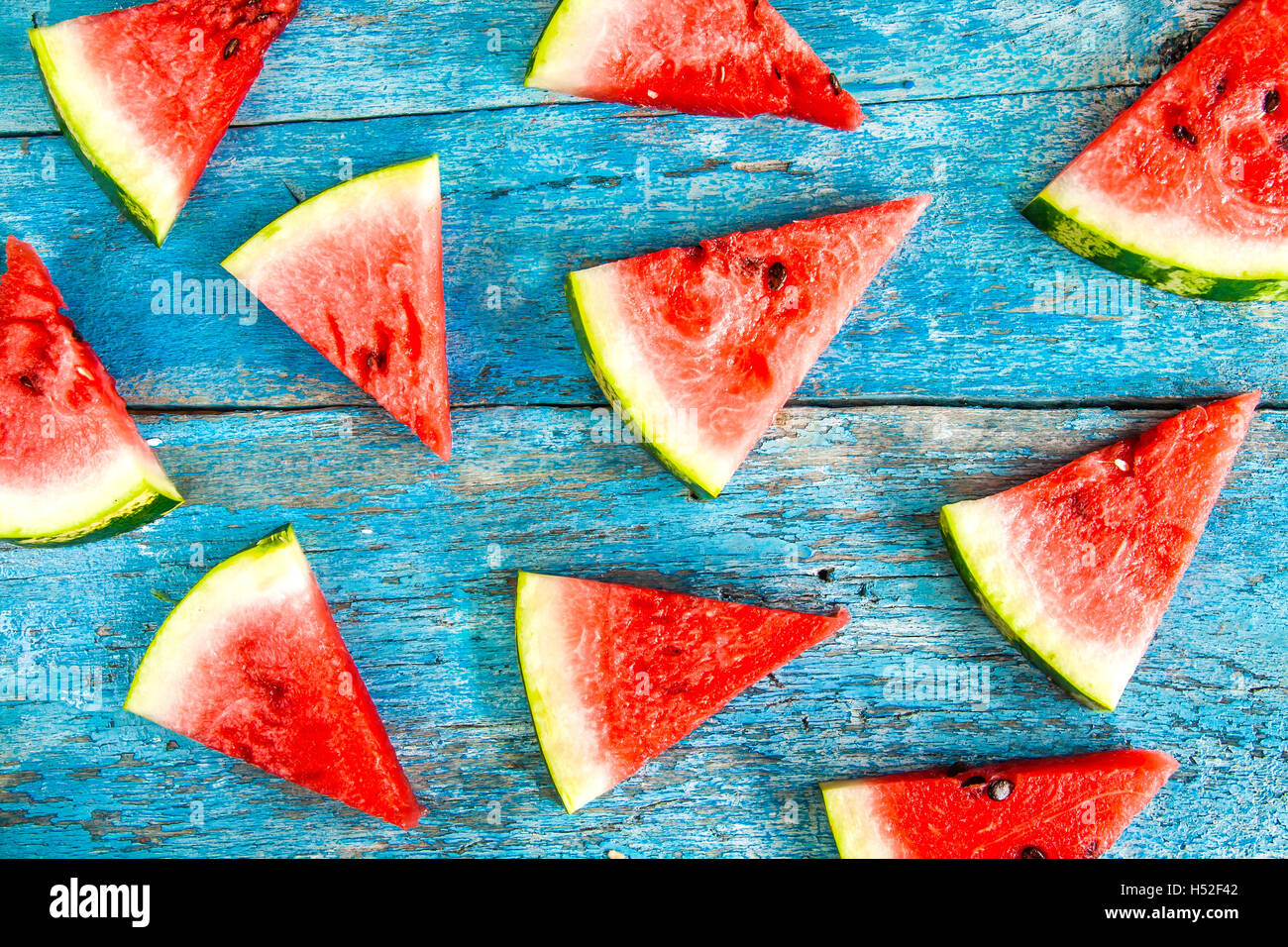 on a blue background flat triangles of watermelon Stock Photo - Alamy