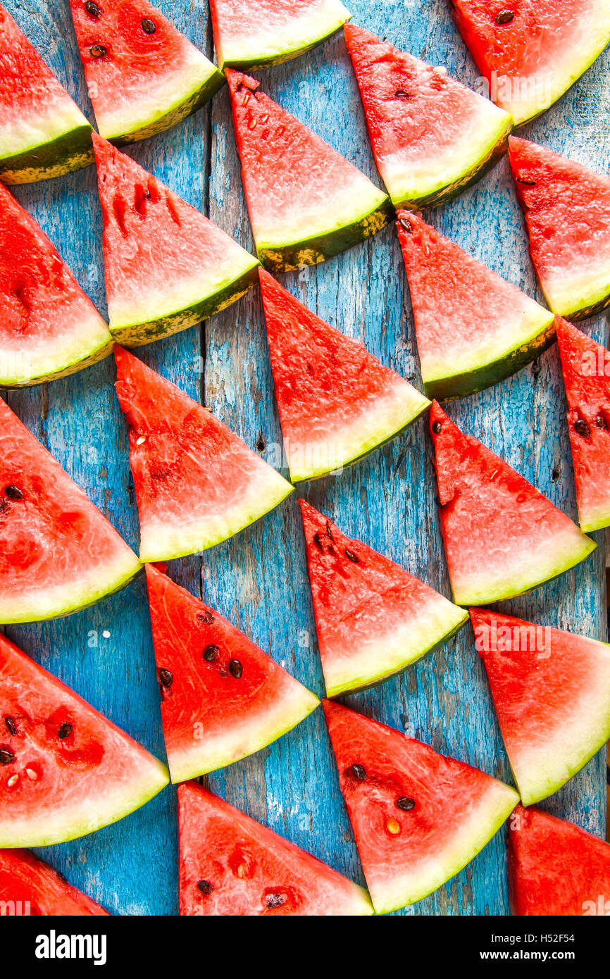 on a blue background flat triangles of watermelon Stock Photo - Alamy