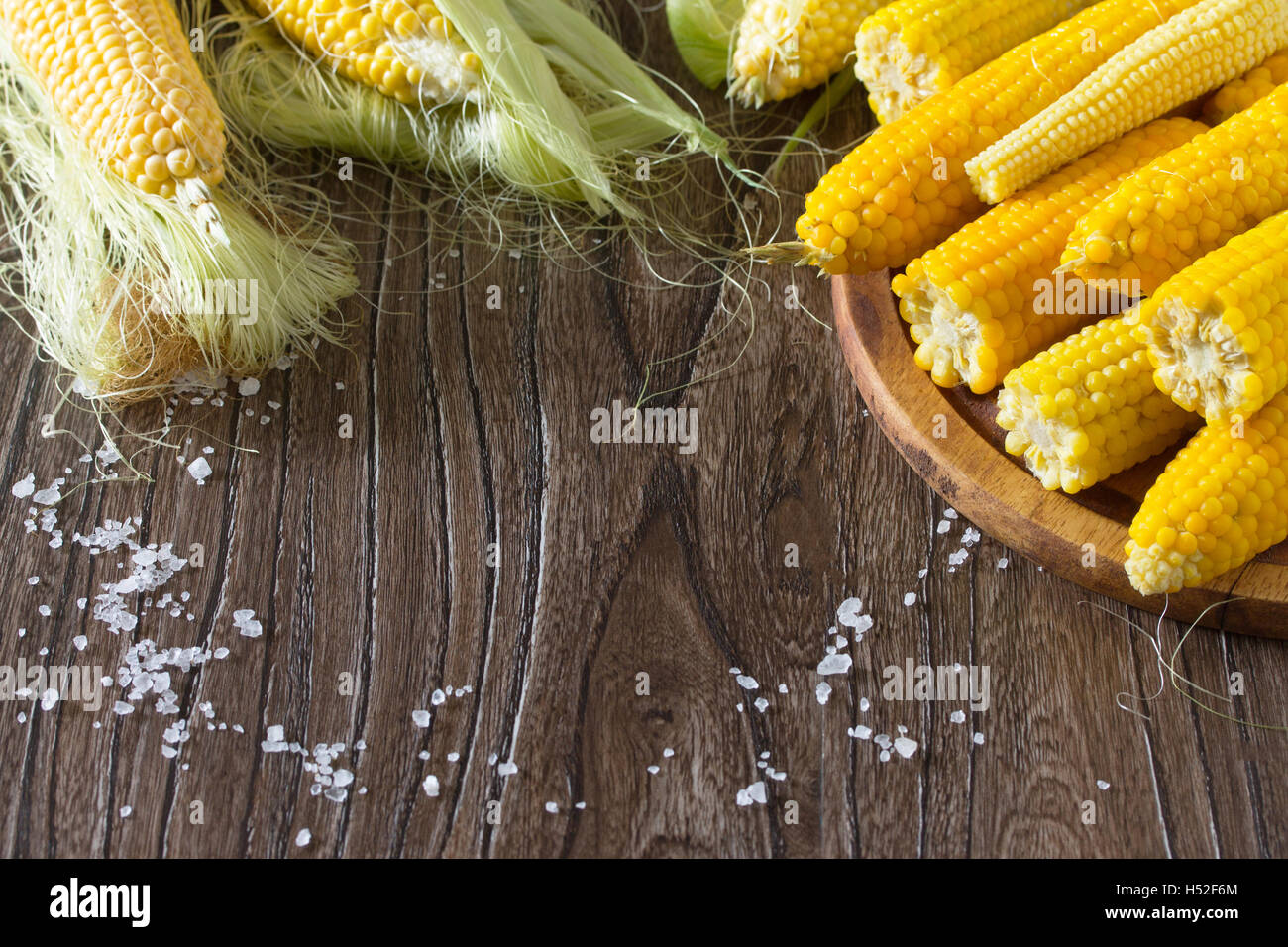Cooked sweet corn and salt on a wooden table. Space for text Stock ...