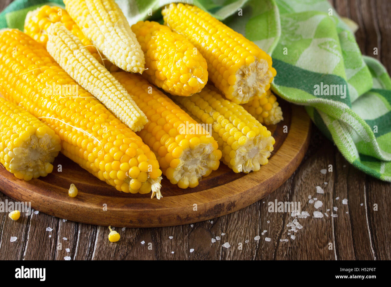 Cooked sweet corn and salt on a wooden table Stock Photo - Alamy