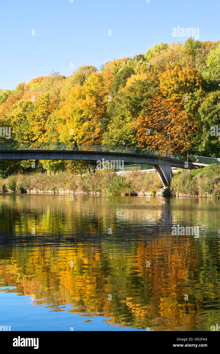 Autumn foliage colour, reflected in the river Wear, at Baths Bridge ...