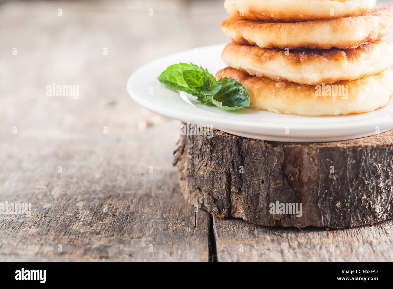 stack of cheesecakes on a white plate and a dark wooden background ...
