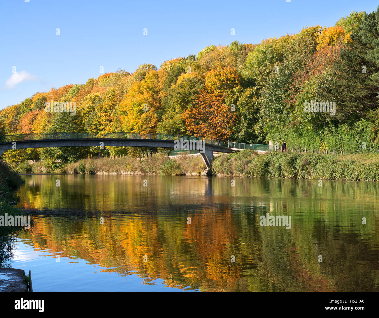 Autumn foliage colour, reflected in the river Wear, at Baths Bridge ...