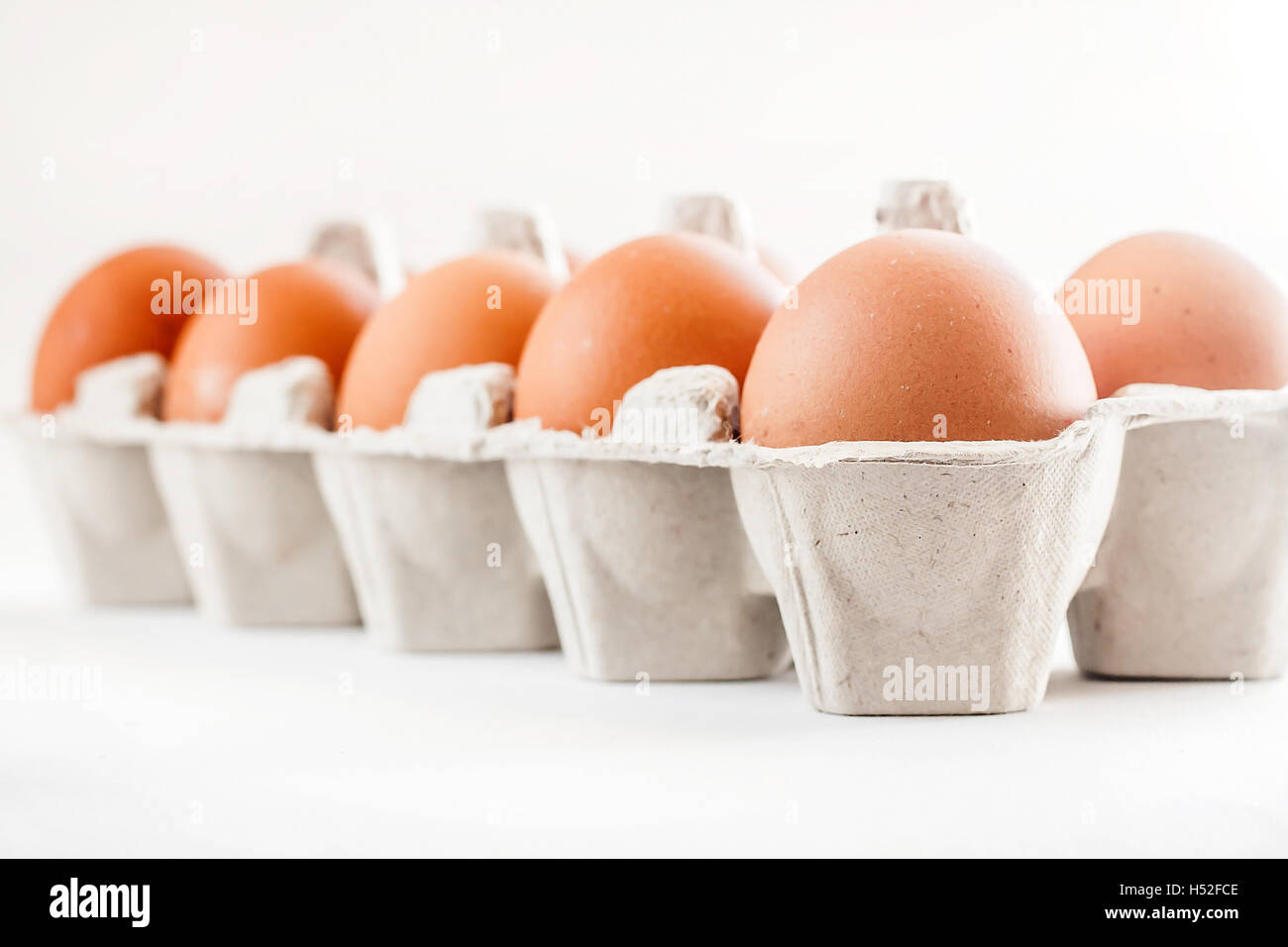 full carton of brown eggs on a white background Stock Photo - Alamy