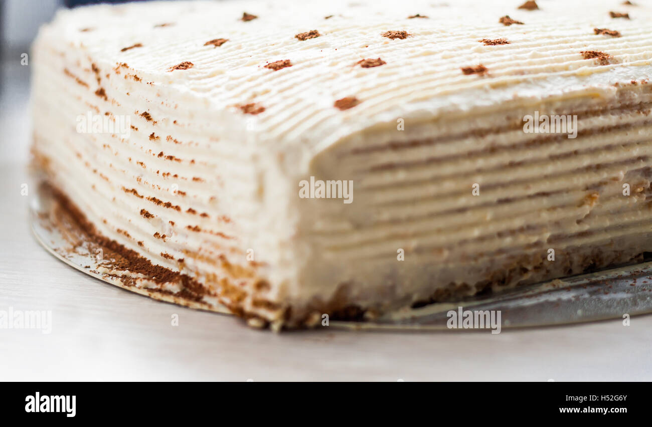 Angle square cream cake decorated with cocoa Stock Photo - Alamy
