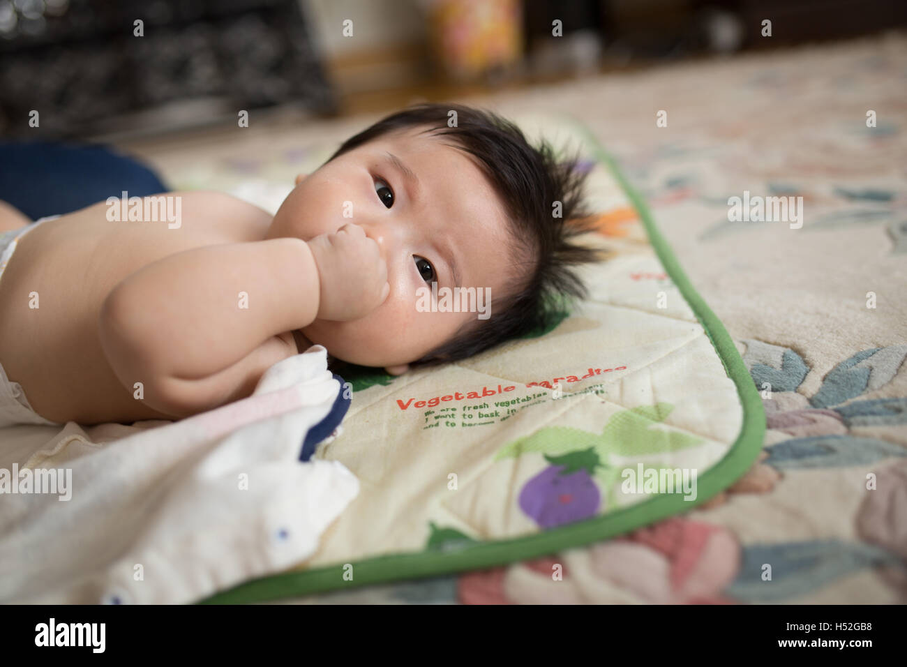 A baby lying down Stock Photo - Alamy