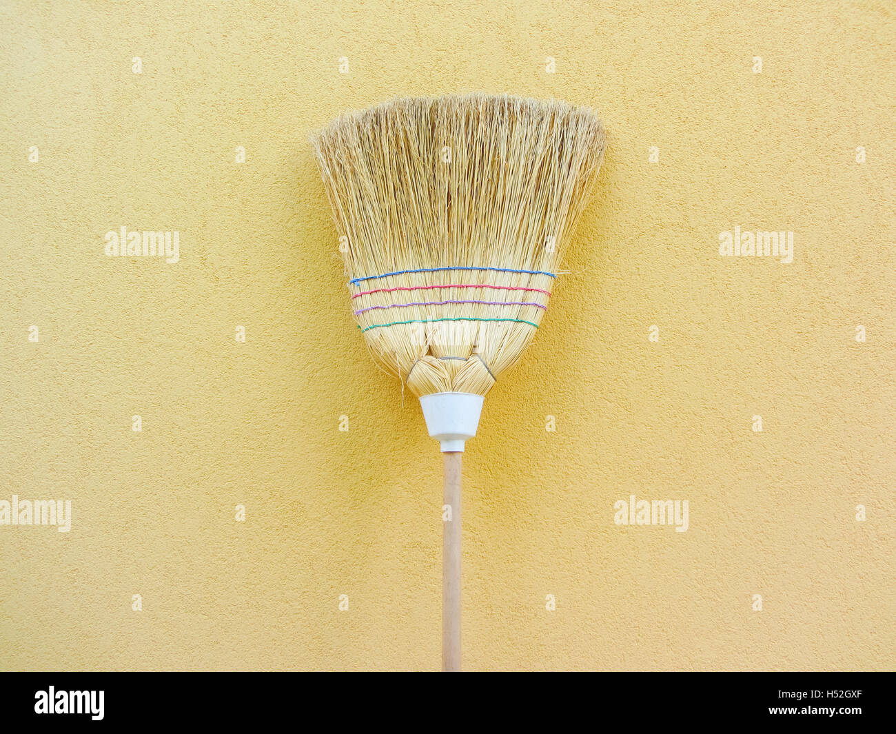isolated country broom on yellow background Stock Photo - Alamy