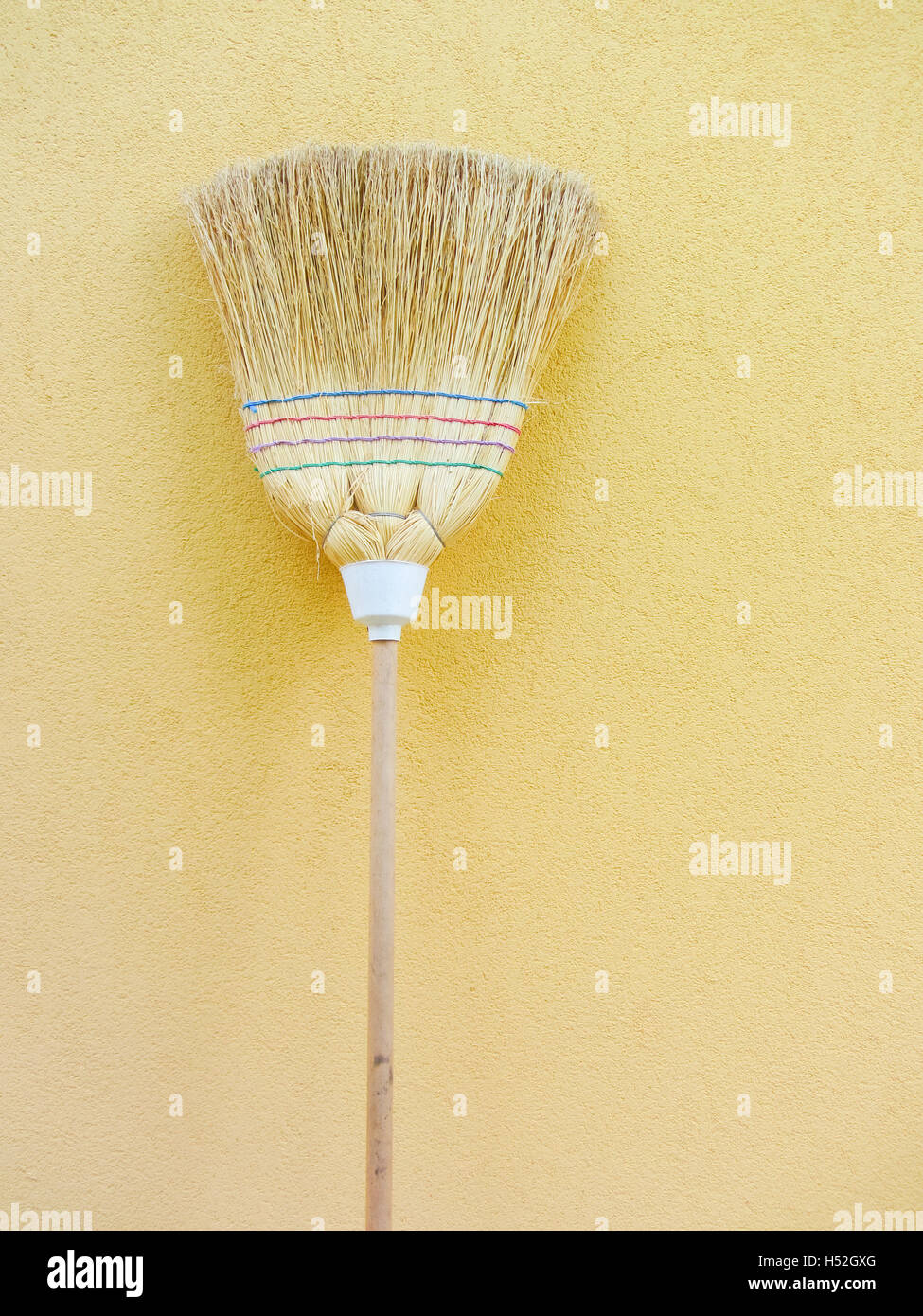 isolated country broom on yellow background Stock Photo - Alamy