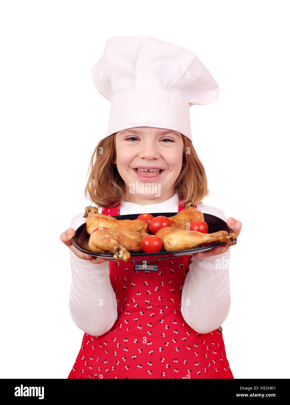 happy little girl cook hold dish with chicken drumstick Stock Photo - Alamy