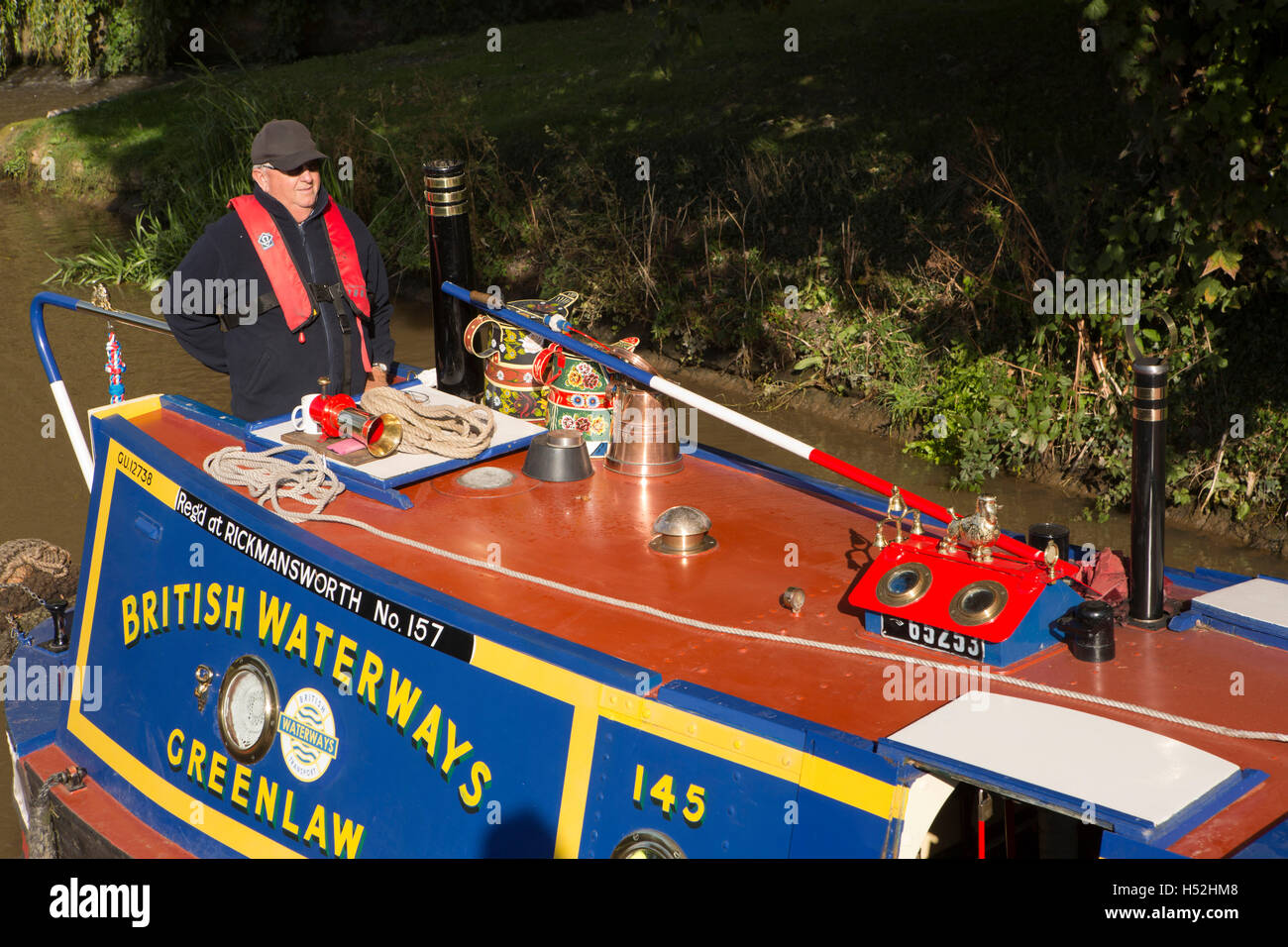 UK, England, Cheshire, Beeston Brook, man steering narrowboat Greenlaw ...