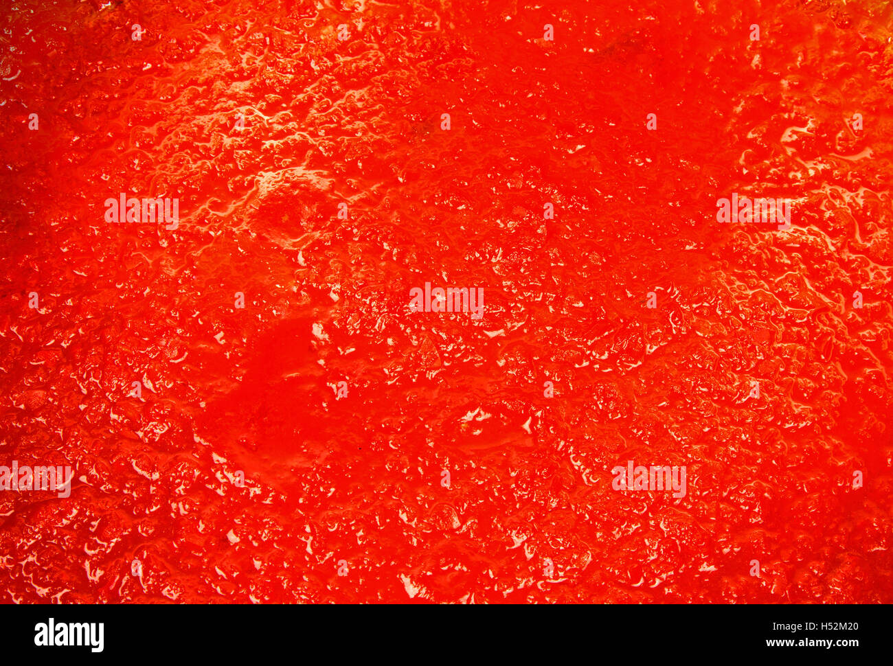 Photo of a very close puree of red peppers in a pot. Closeup, flat ...