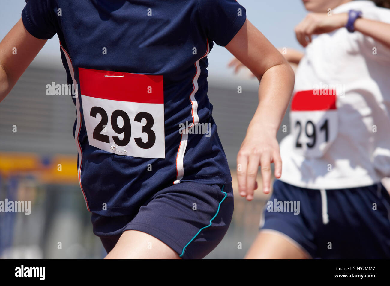 Male runners finalizing a race in a running track. Horizontal Stock ...
