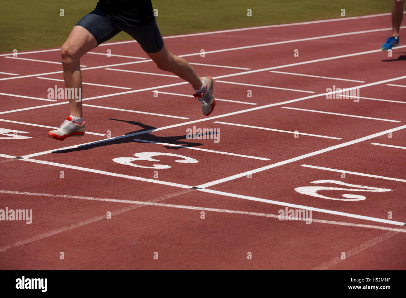 Detail of a male athlete in a running track. Horizontal Stock Photo - Alamy