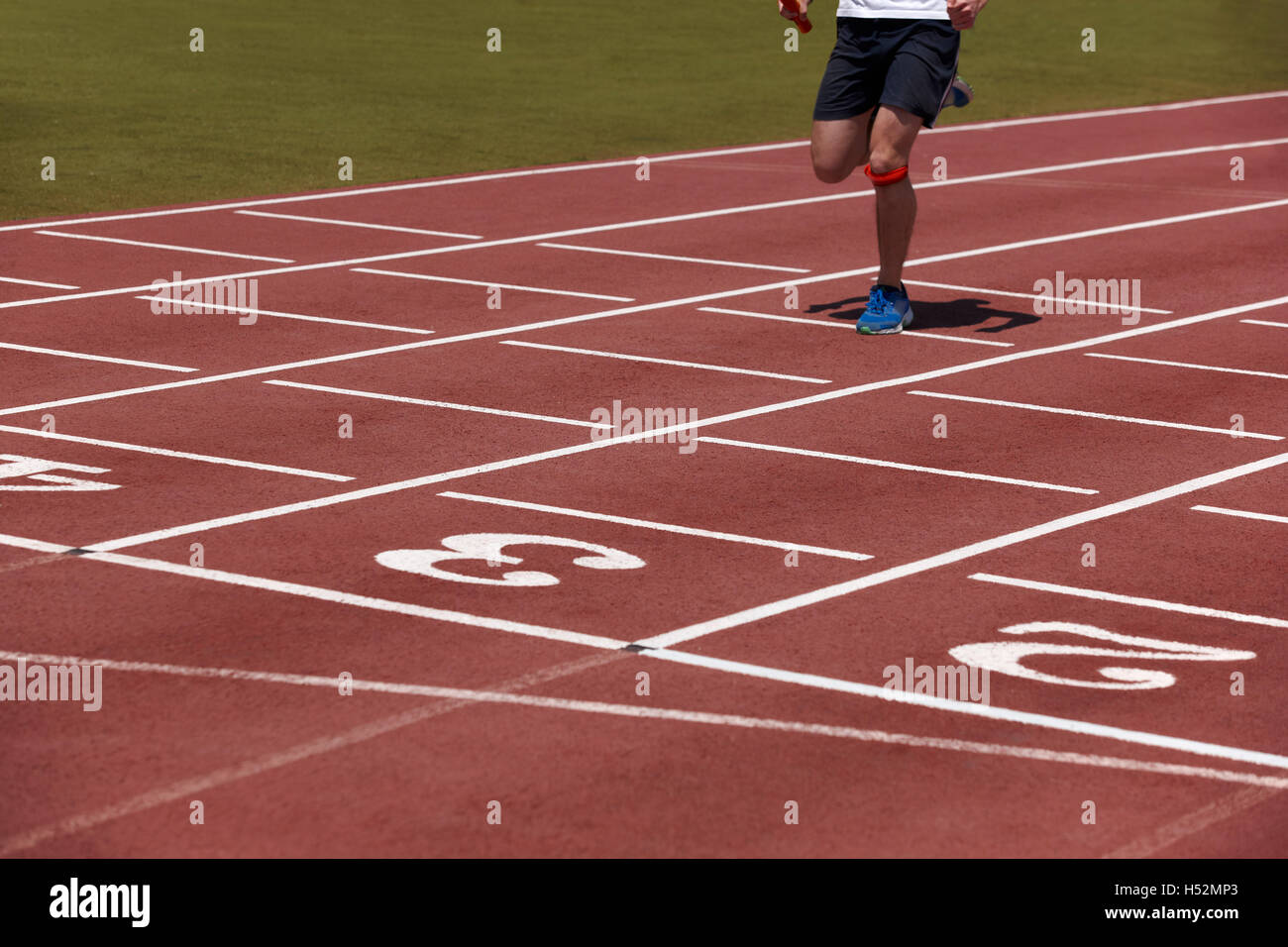 Detail of a male athlete in a running track. Horizontal Stock Photo - Alamy