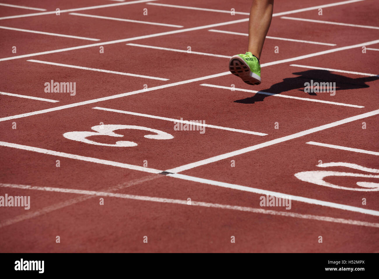 Detail of a male athlete leg crossing the finish line. Horizontal Stock ...
