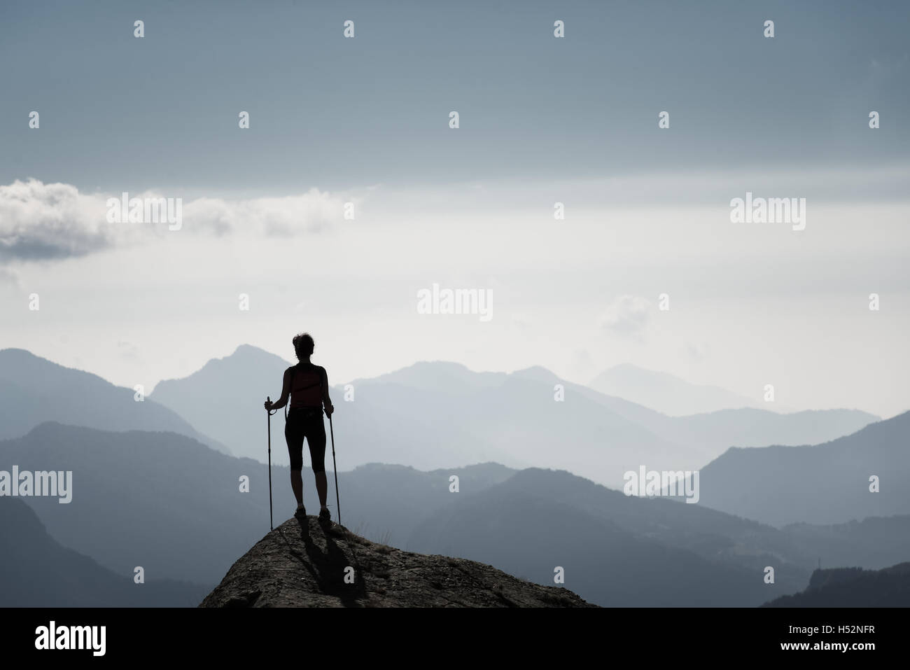 Girl on the top of a mountain looking horizon Stock Photo - Alamy
