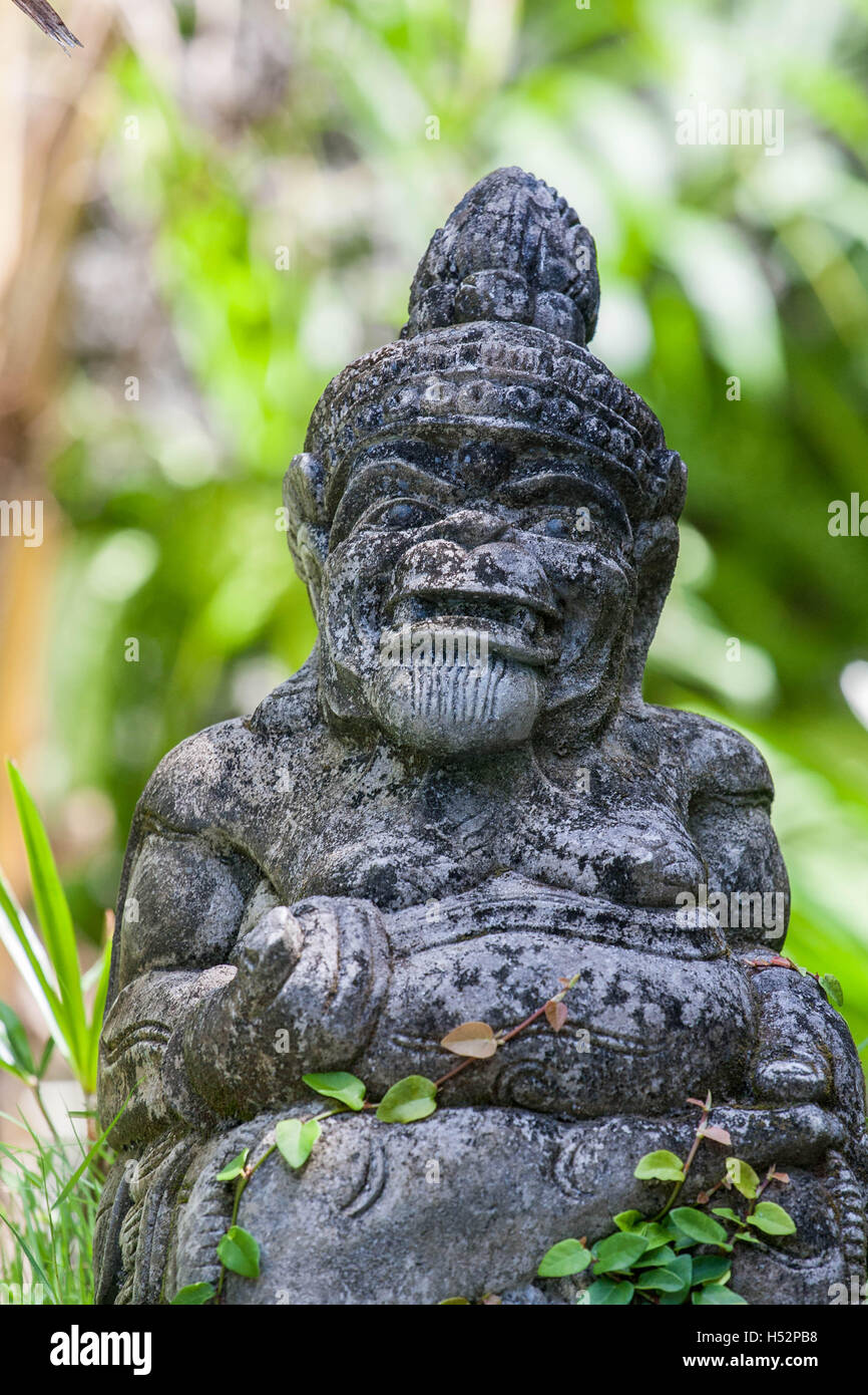 Little Statue in a garden in Bali Stock Photo - Alamy
