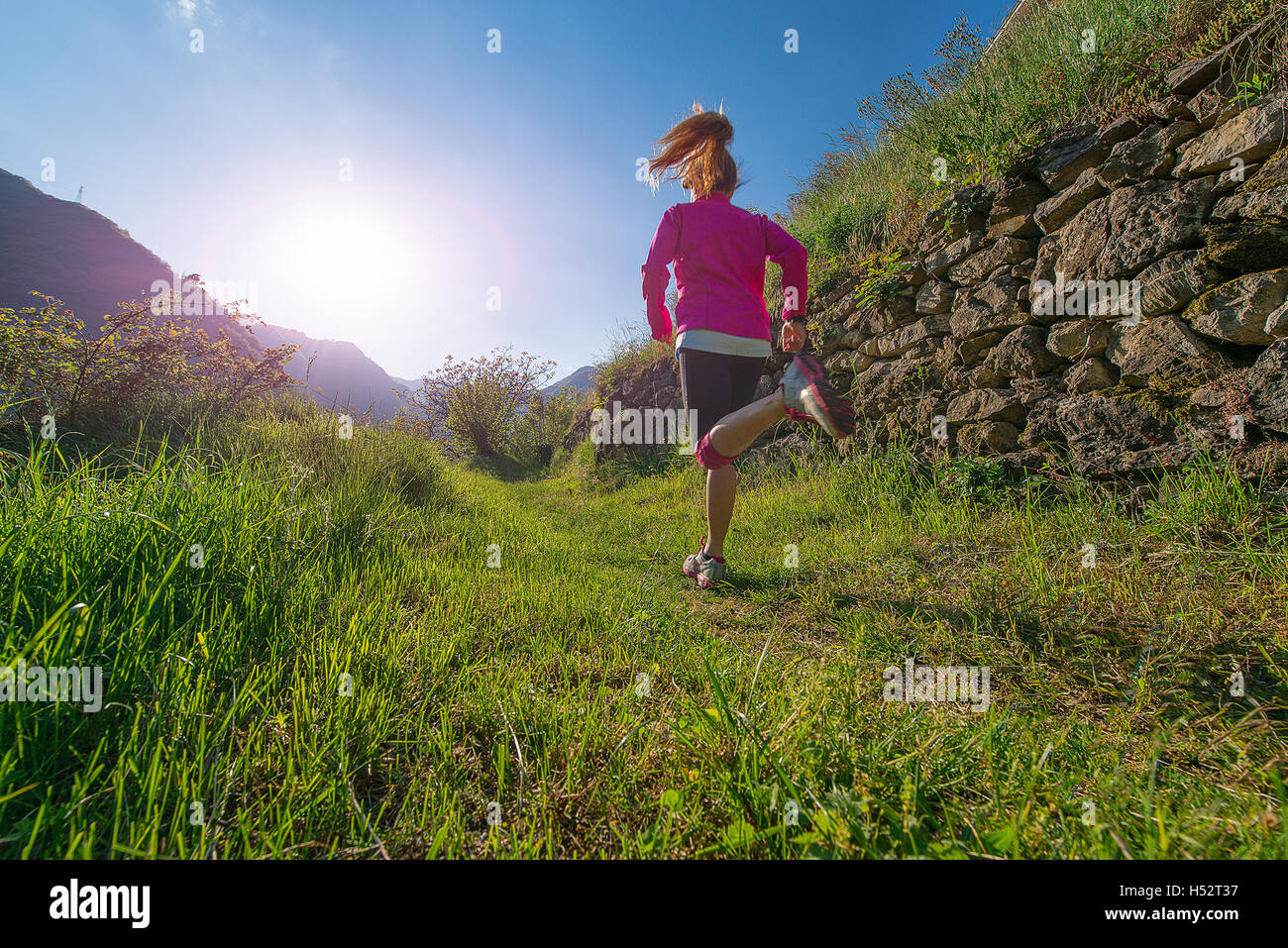 Girl athlete runs in the nature trail in the meadow Stock Photo - Alamy