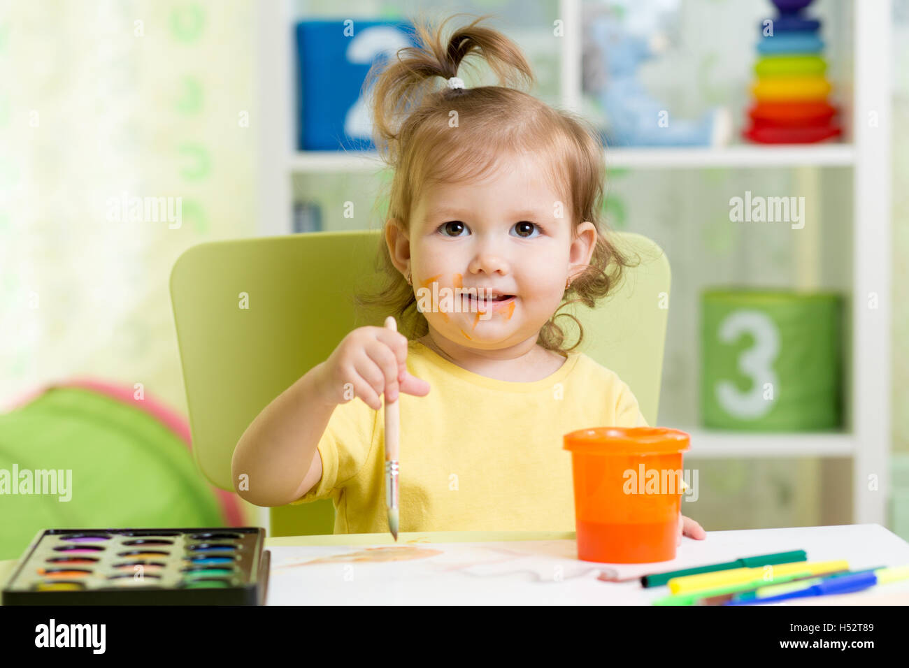 Child girl painting with watercolors at home or school nursery Stock ...