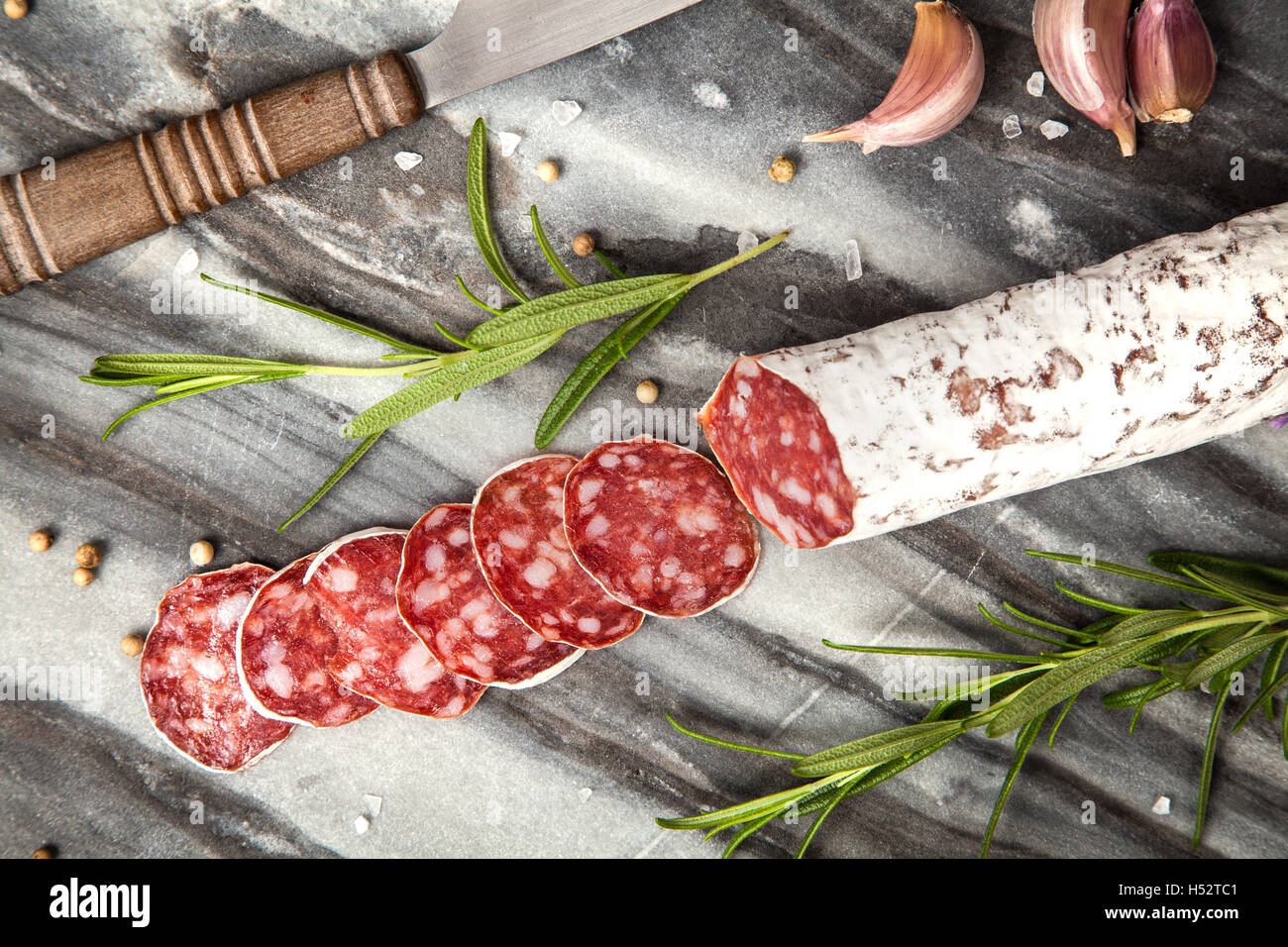 Salami on dark background Stock Photo - Alamy