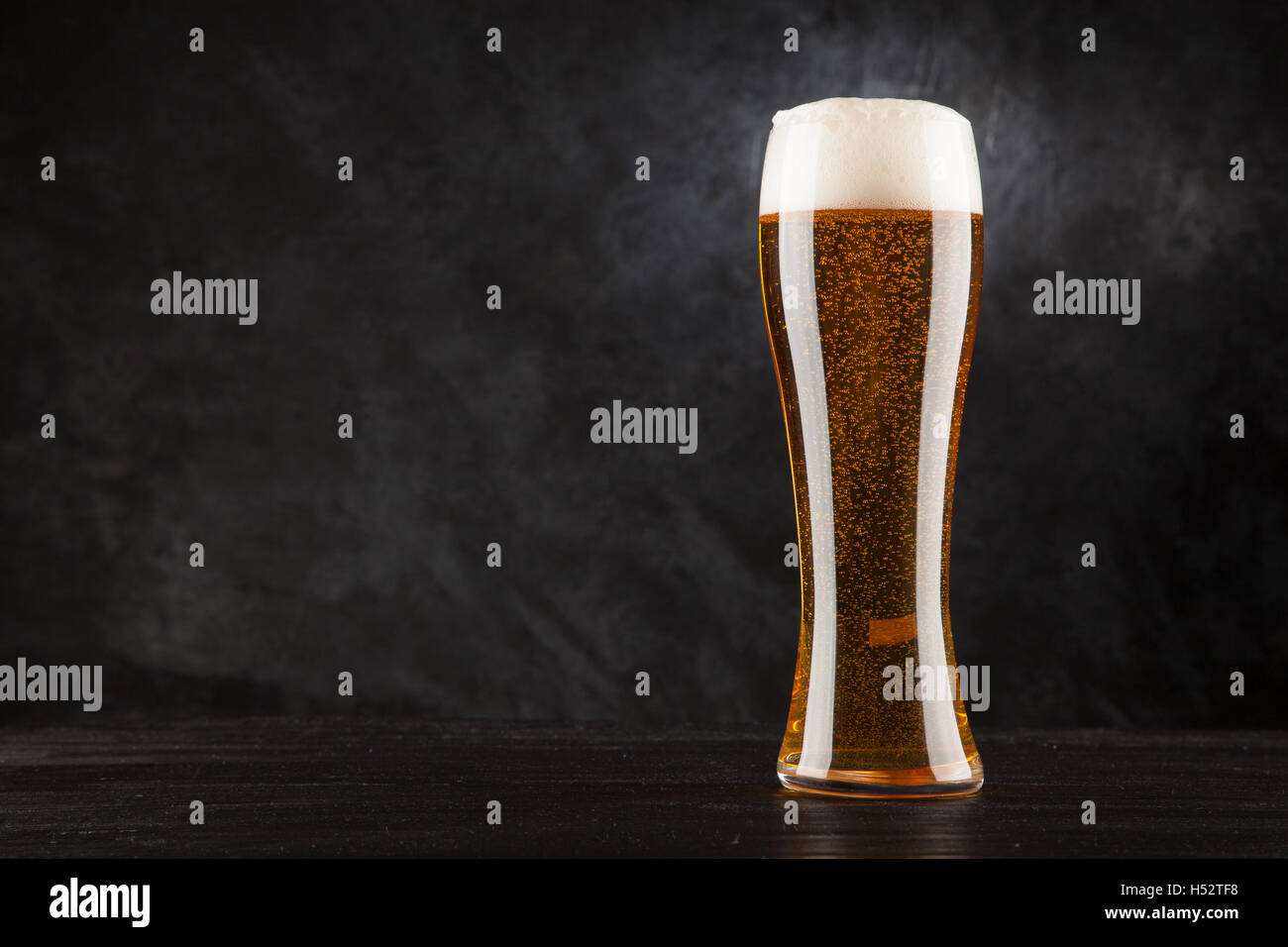 Beer glass on dark background Stock Photo - Alamy
