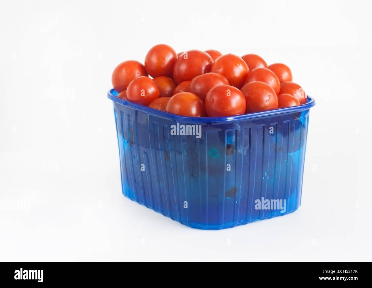 blue plastic box full of tomatoes isolated Stock Photo - Alamy