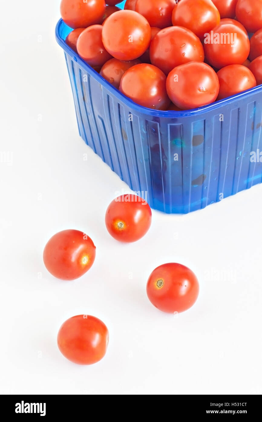 blue plastic box full of tomatoes isolated Stock Photo - Alamy