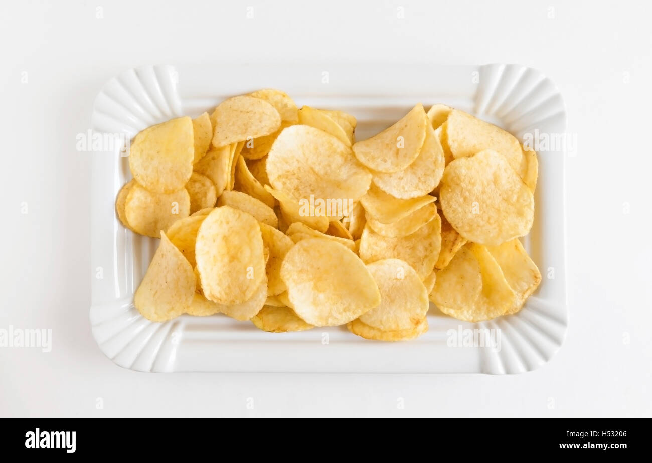 potato chips in a white dish isolated Stock Photo - Alamy