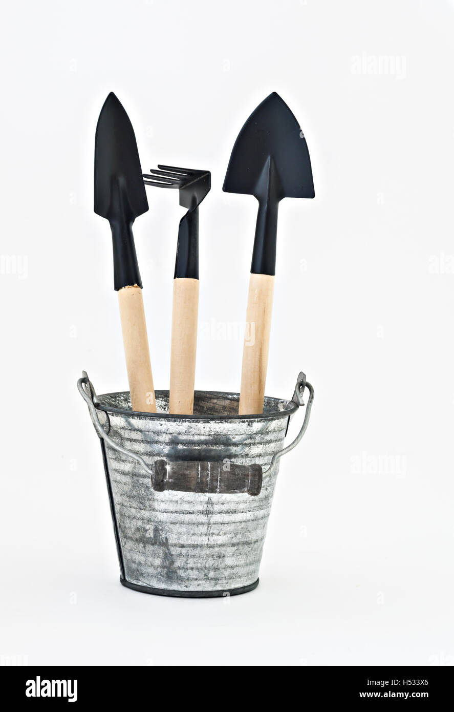 garden shovel, rake and a metal bucket isolated Stock Photo - Alamy