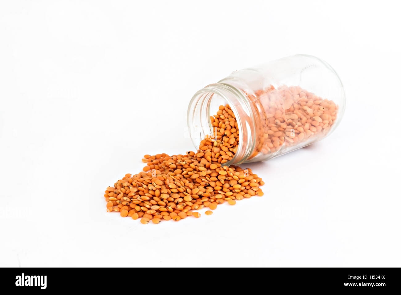 red lentils spilled from the container isolated Stock Photo - Alamy