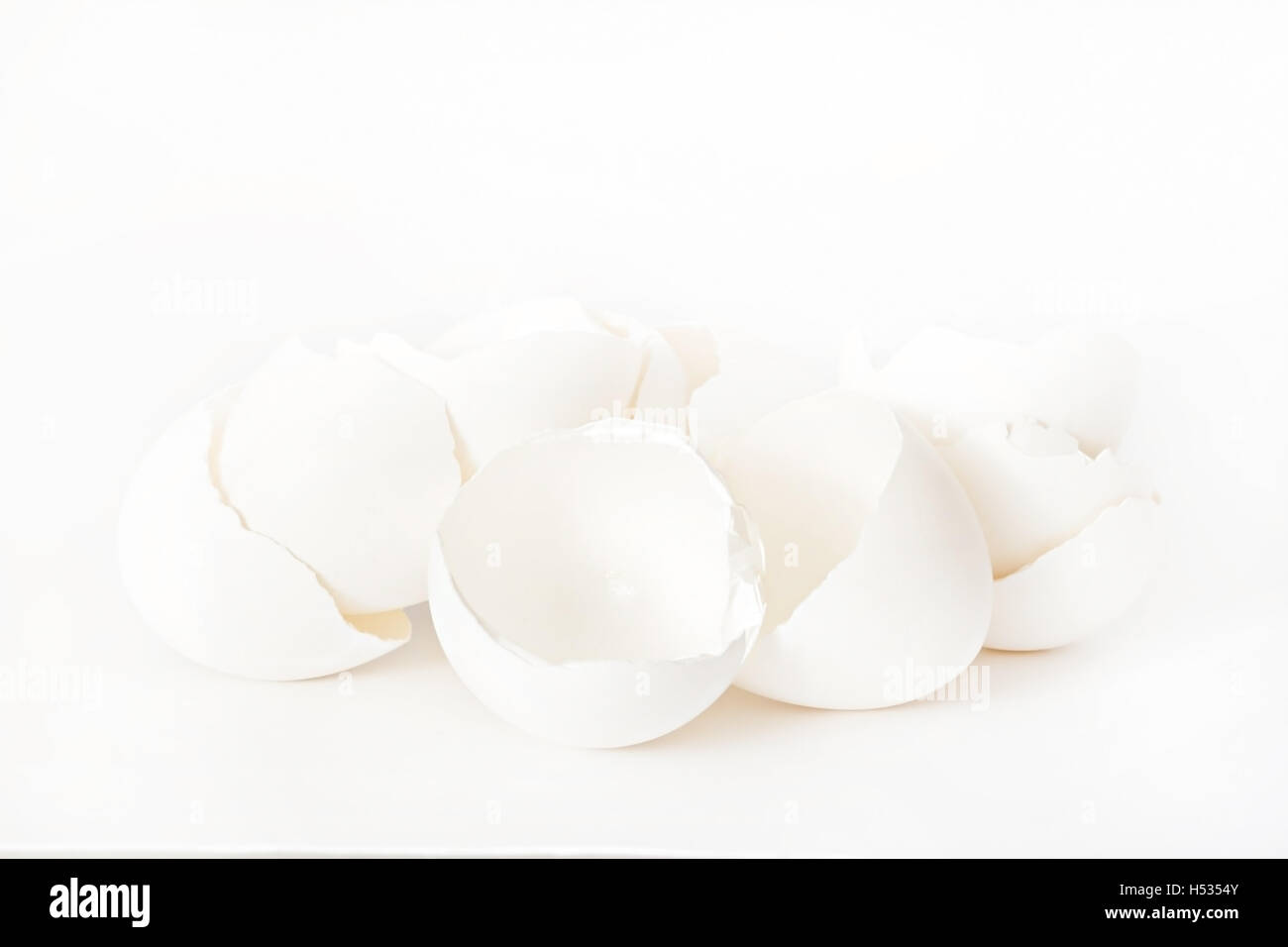 White eggshells on a white background isolated Stock Photo - Alamy