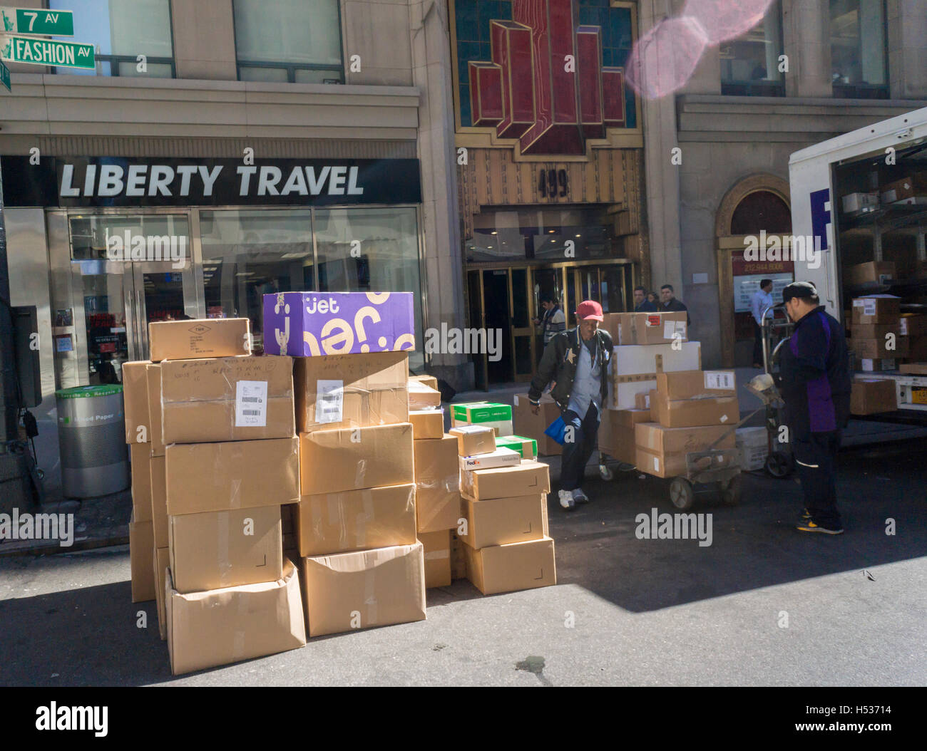 A FedEx worker sorts deliveries, including a box from Walmart owned Jet ...